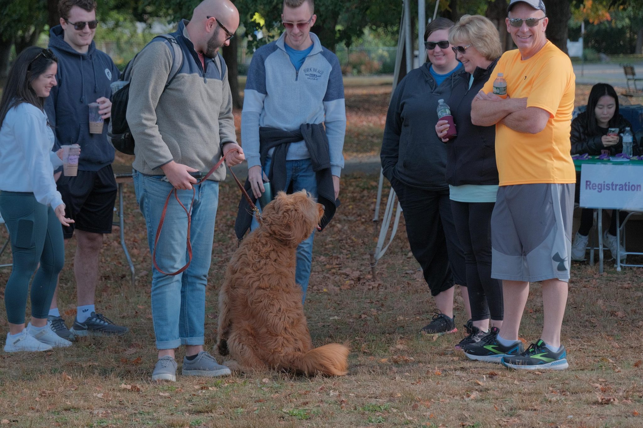 Some attendees and their dog wait for the things to begin