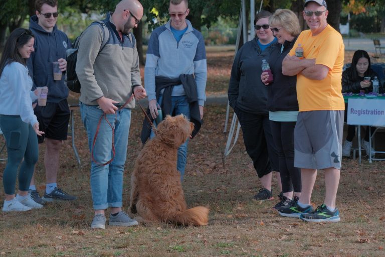 Some attendees and their dog wait for the things to begin